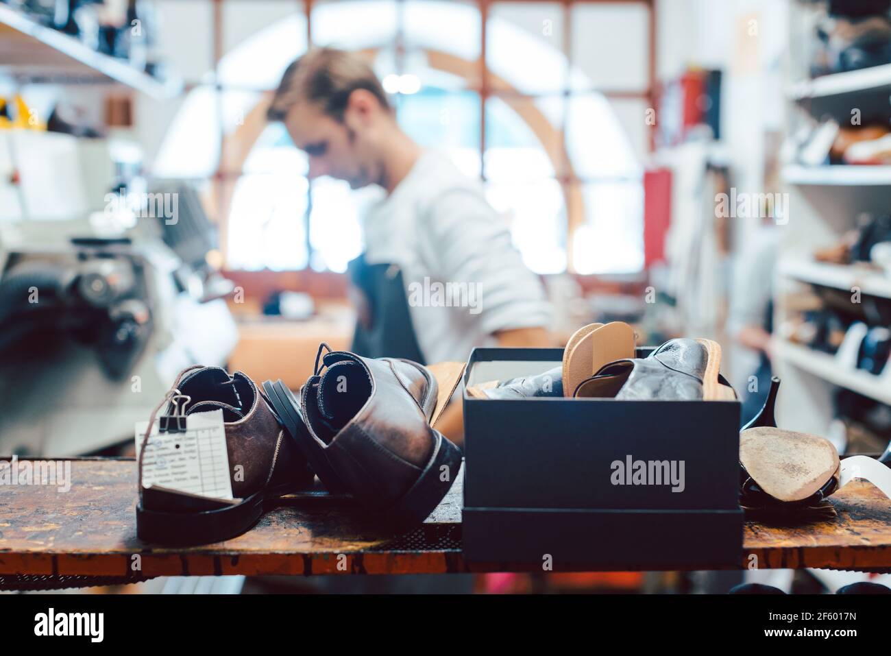 Shoemaker or cobbler in his traditional workshop Stock Photo - Alamy
