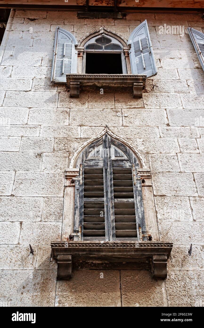 Classic old windows on a stone wall. Elements of European traditional ...