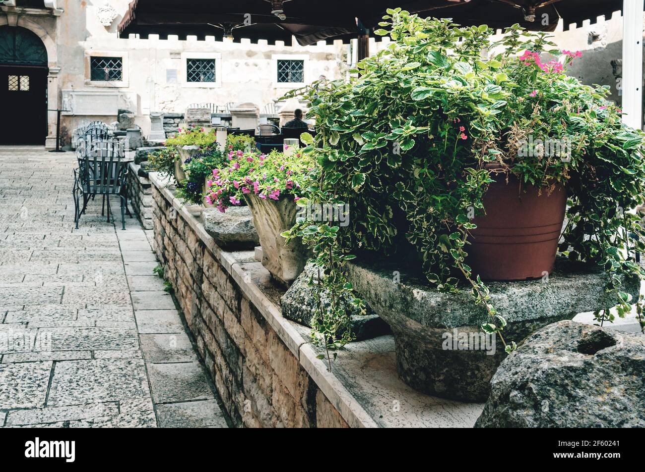 group of elaborately decorated flower pots on the street of a typical ...