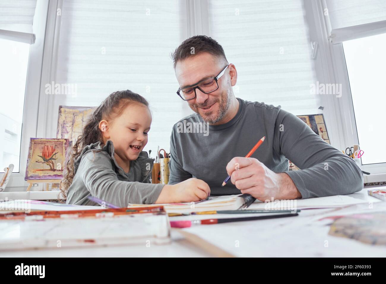 Happy family creative art activity. Caring dad or babysitter drawing ...