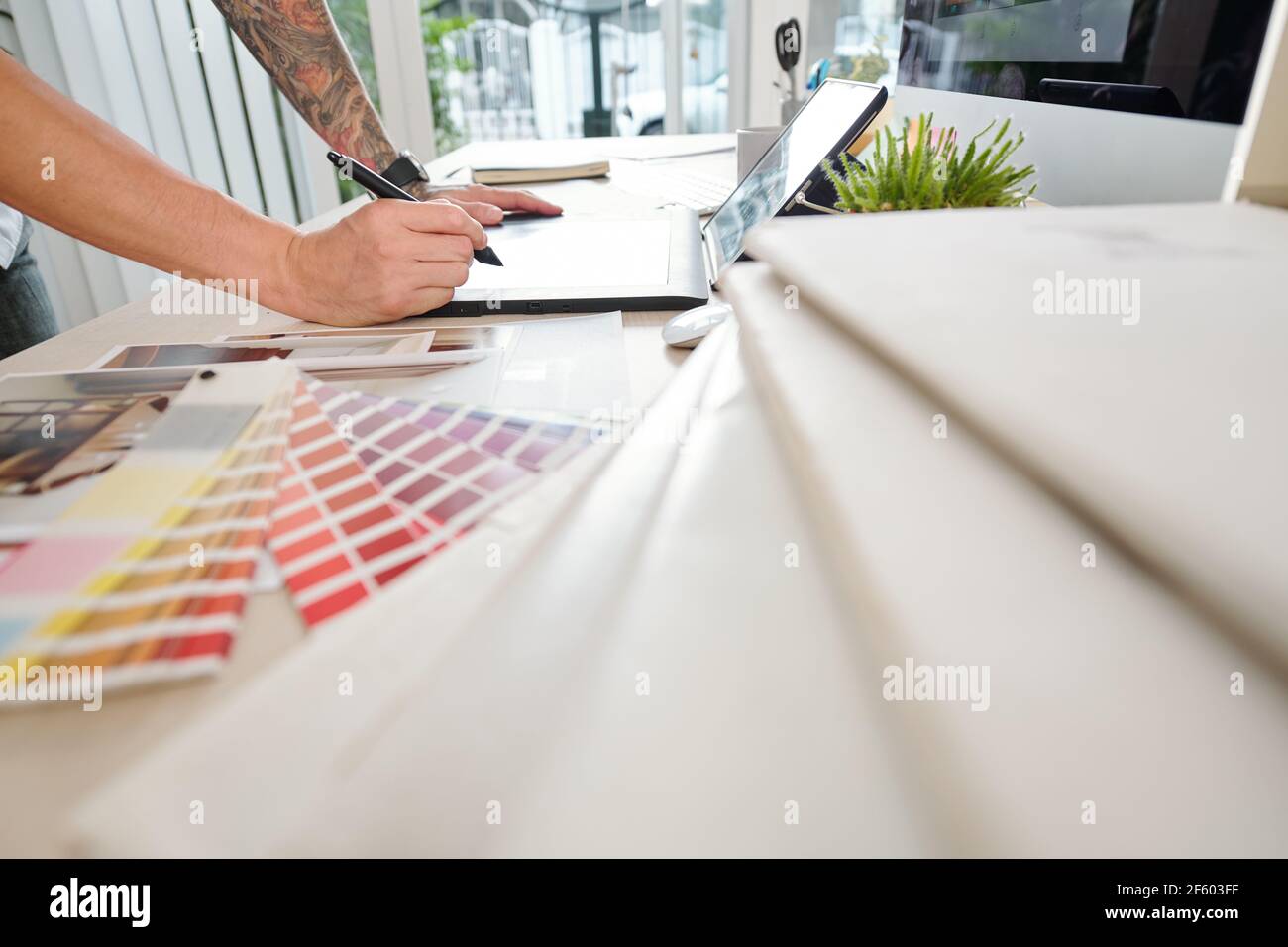 Hands of graphic designer drawing on tablet computer with digital pen ...