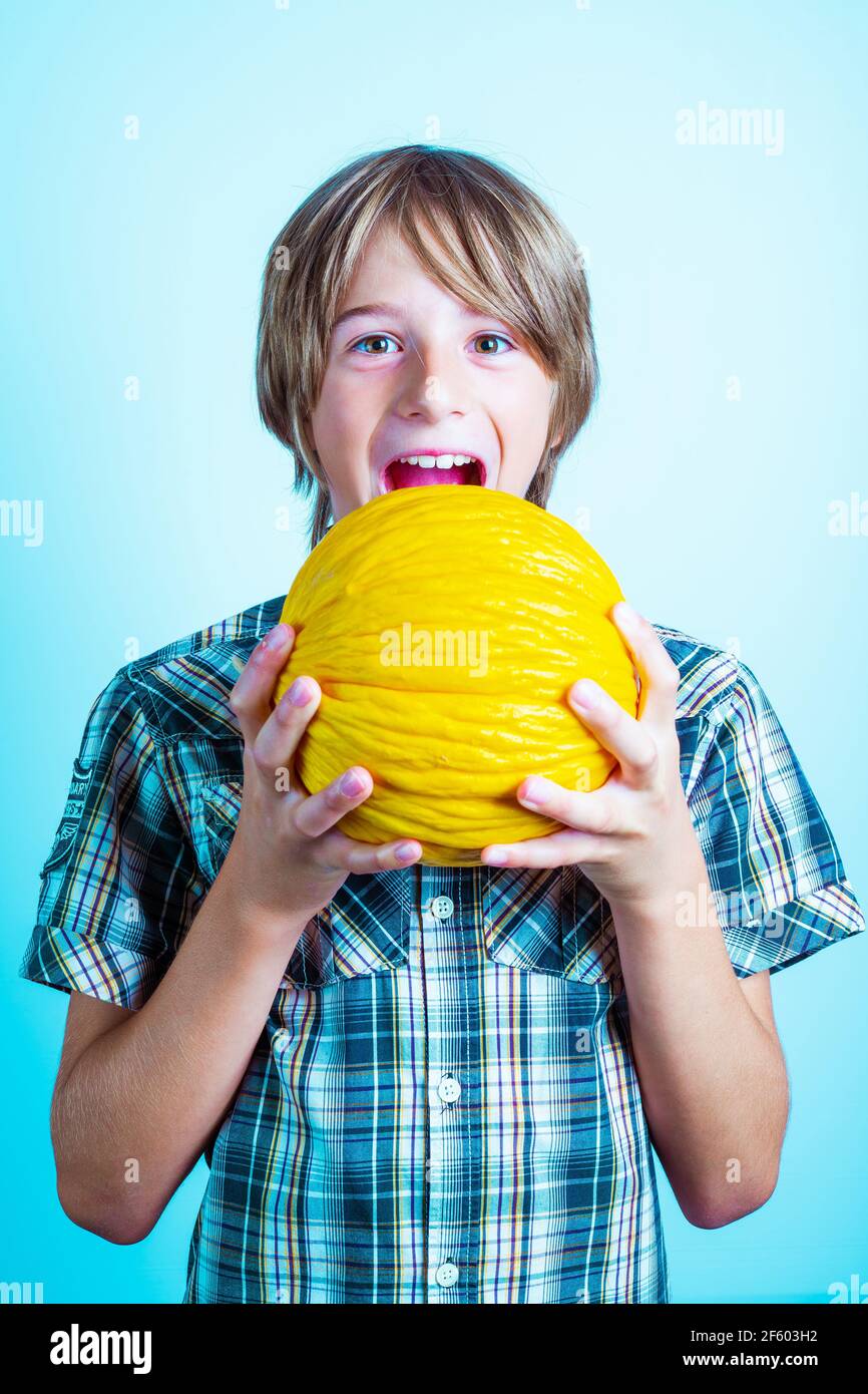 little boy with a big yellow melon Healthy food concept Stock Photo - Alamy