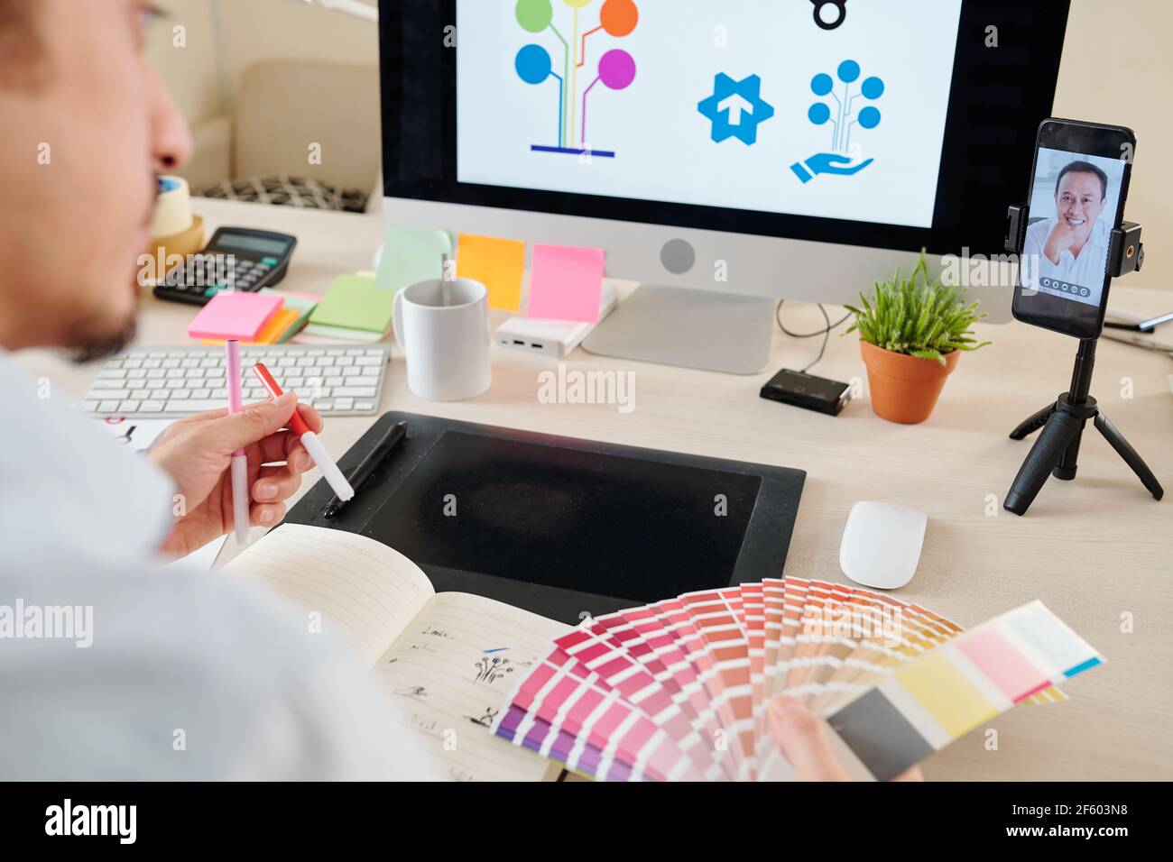 Graphic designer having video call with client when working on logotype ...