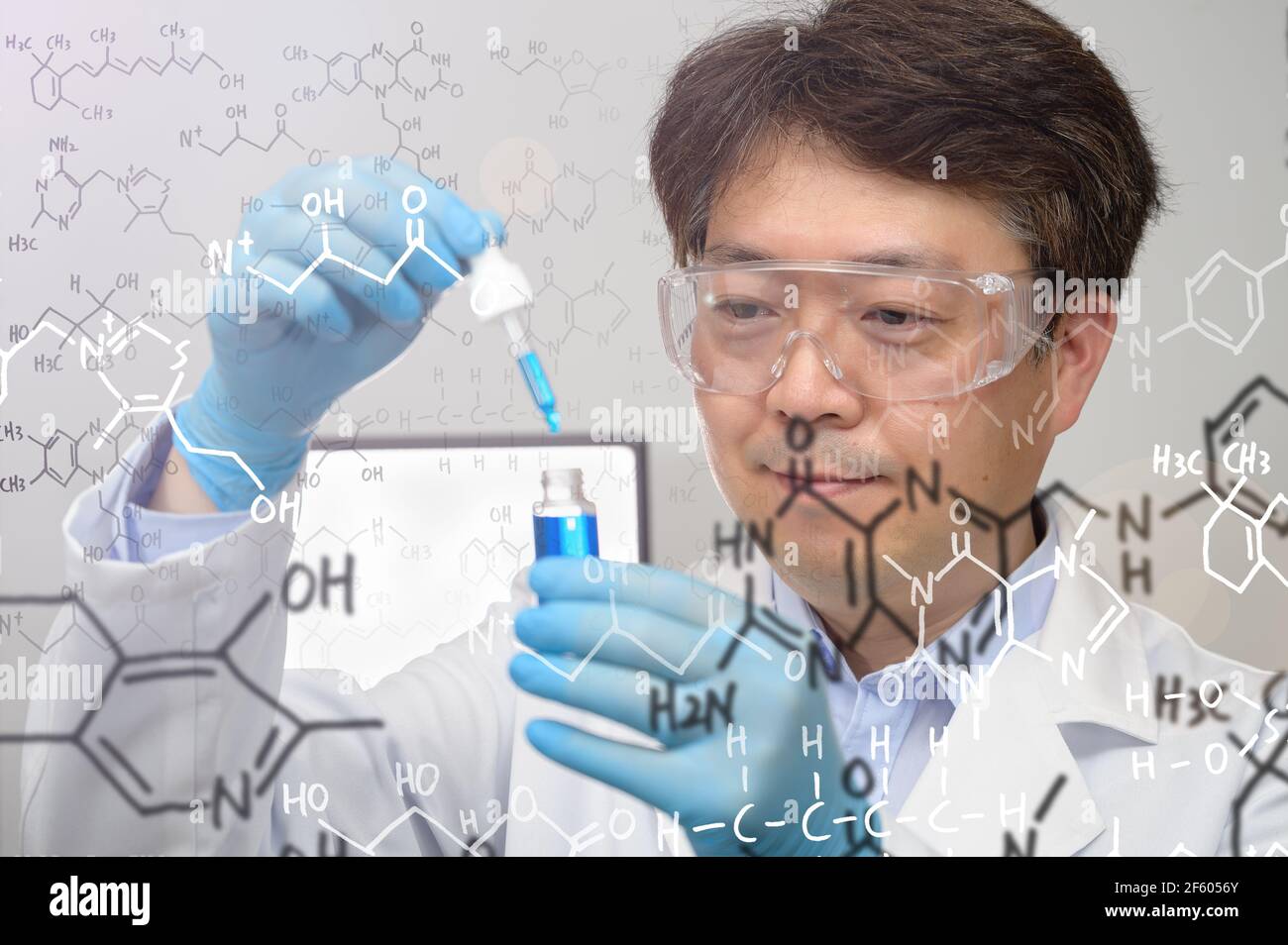 Portrait of a middle-year Asian male scientist wearing a white lab gown ...