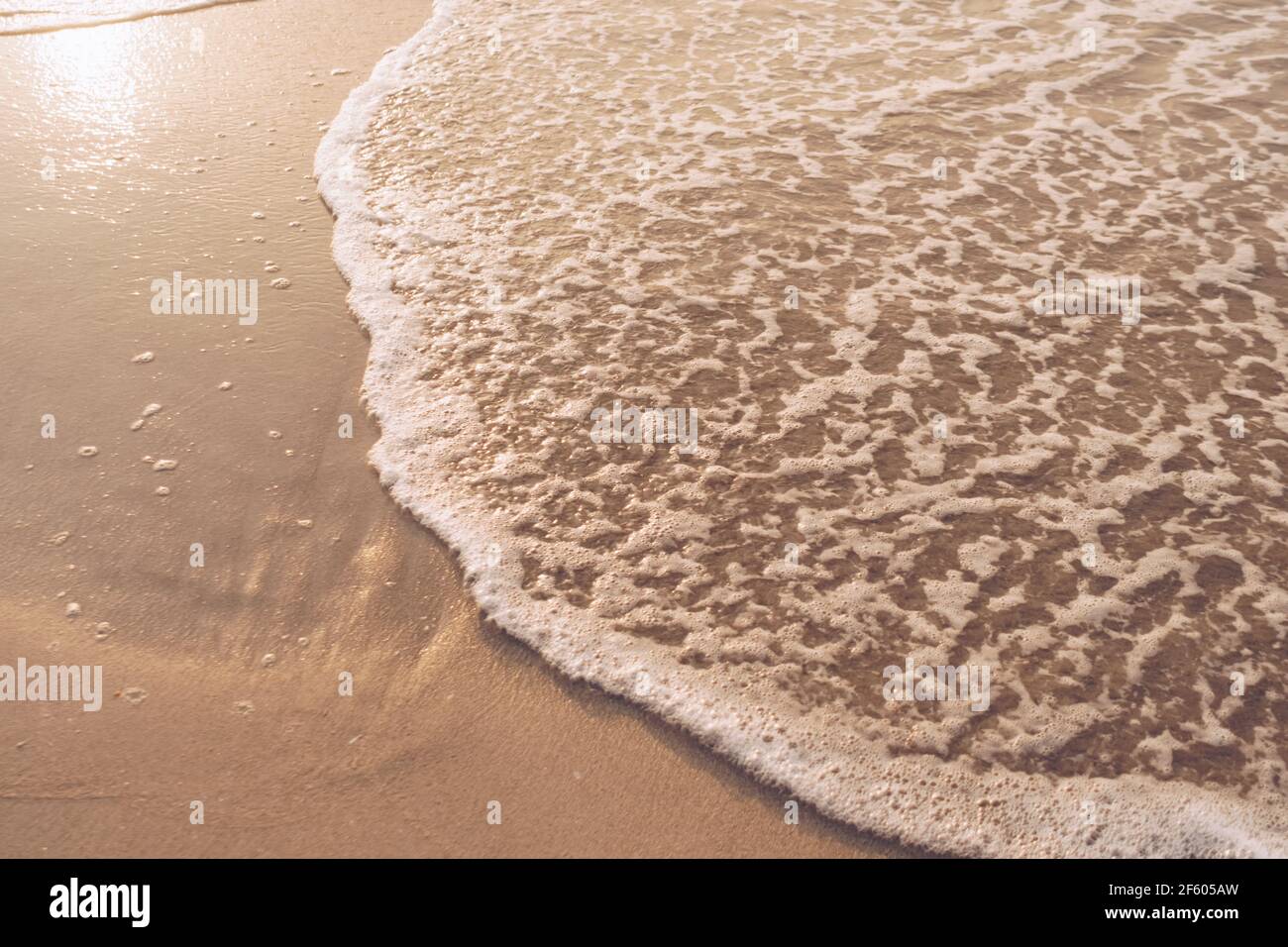 Top view of sand and sea water splash with copy space at tropical clean ...