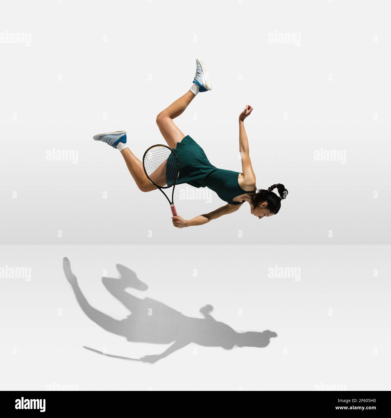 Young caucasian professional sportswoman levitating, flying while ...