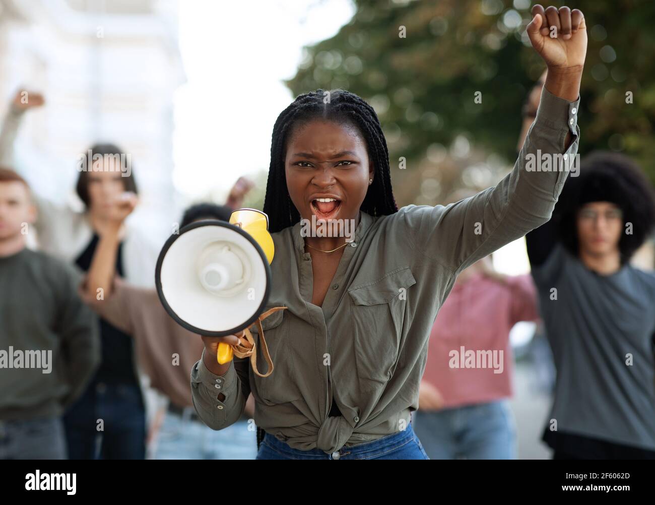 Emotional black lady activist with megaphone on the street Stock Photo ...
