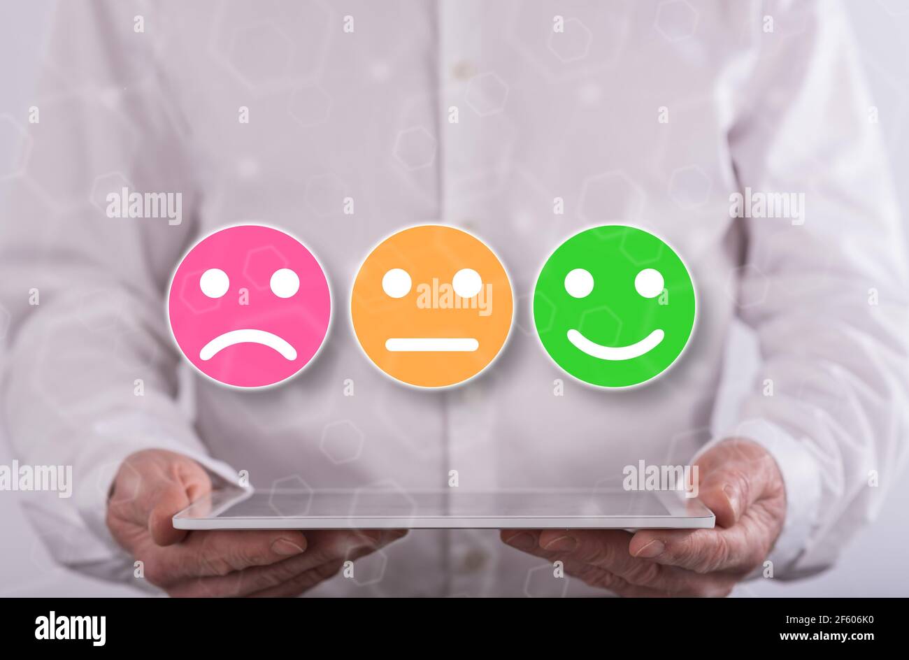 Customer satisfaction concept above a tablet held by a man in ...