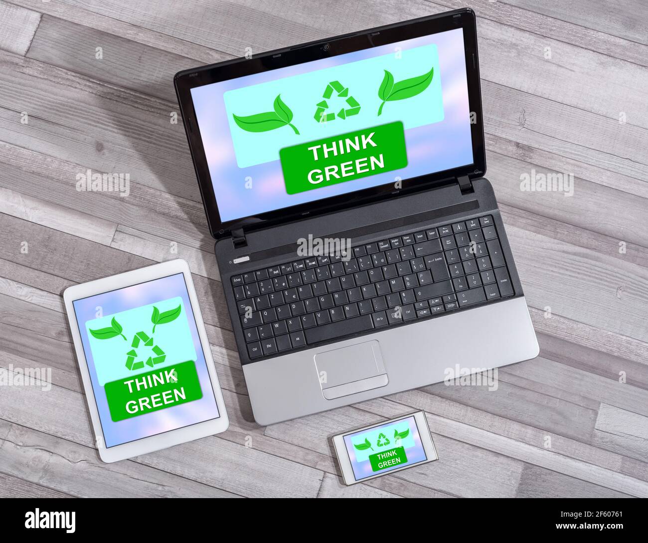 Think green concept shown on different information technology devices ...