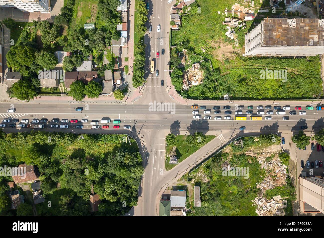 Top down aerial view of busy street intersection with moving cars ...