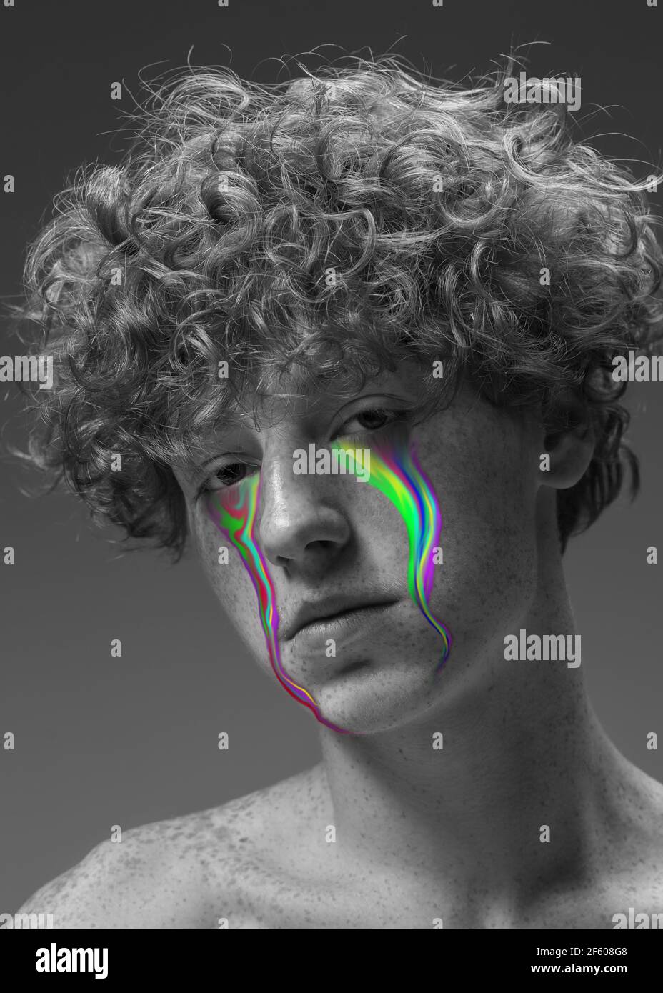 Portrait of young beautiful man with neon, fluid tears from eyes ...