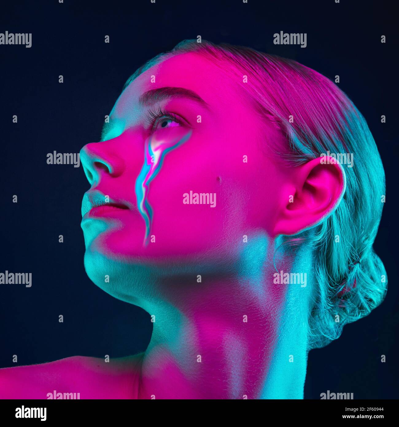 Portrait of young beautiful woman with neon, fluid tears from eyes ...