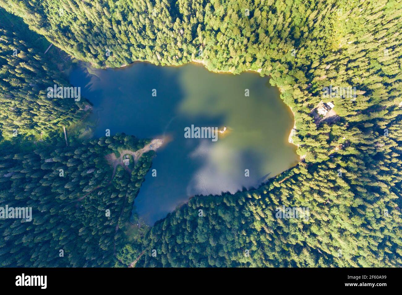 Top down aerial view of big lake with clear blue water between high ...