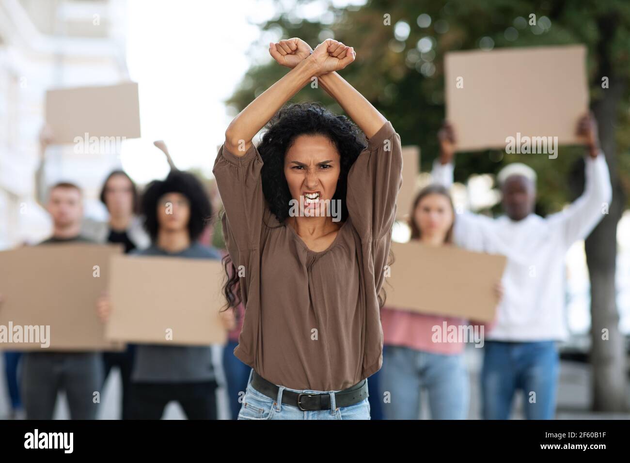 Angry woman leading group of protestors on the street Stock Photo - Alamy