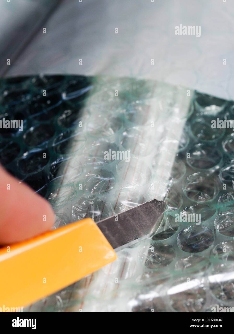 Cutting open a box hi-res stock photography and images - Alamy