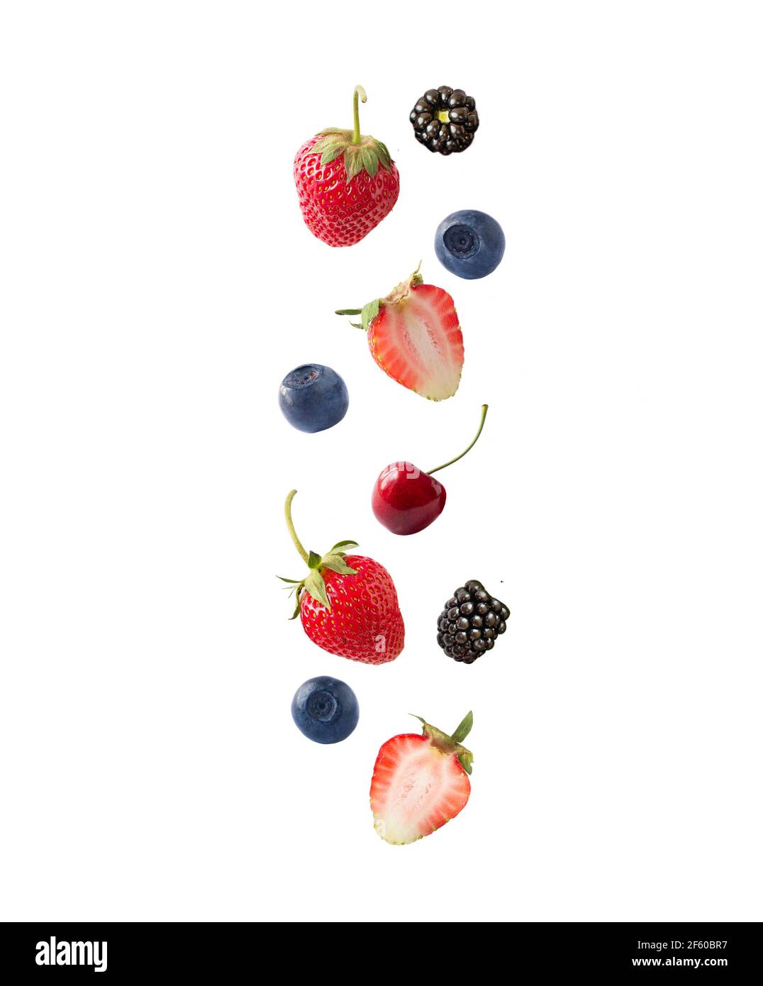 Isolated fresh berries float in the air. Falling blackberry, blueberry ...