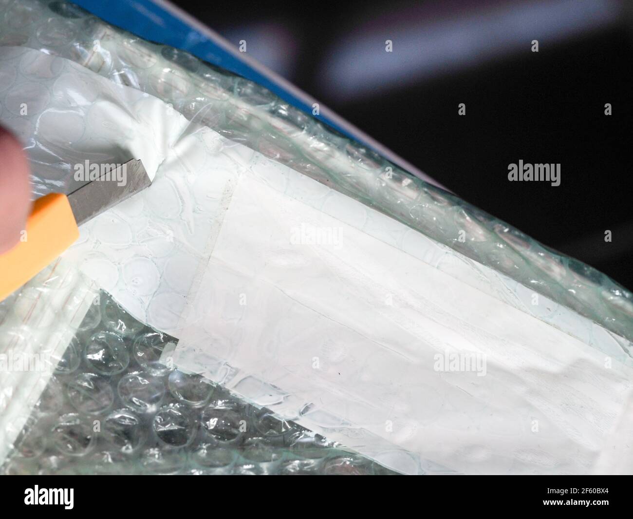 Cutting open a box hi-res stock photography and images - Alamy