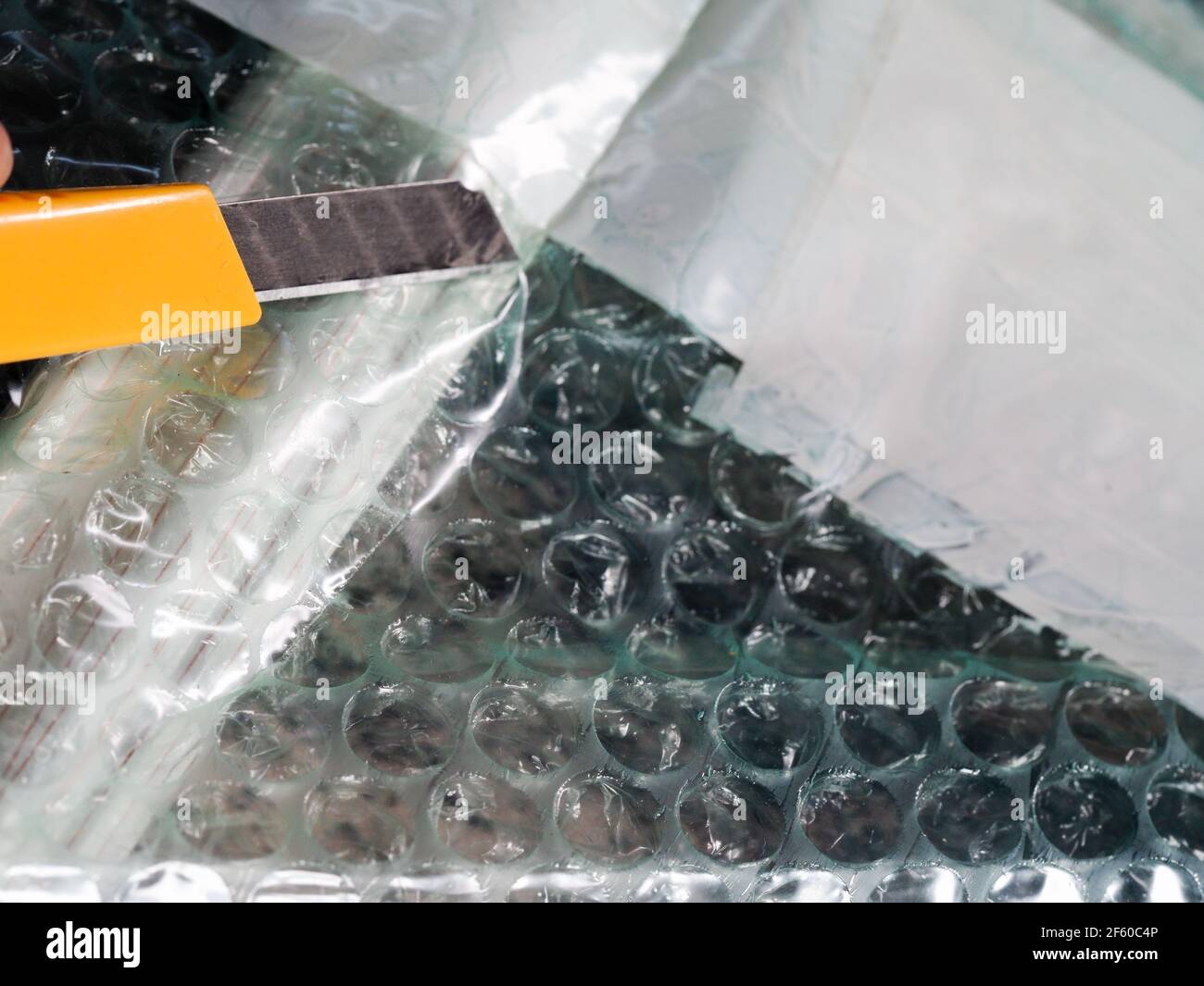 unpacking a box with the help of a cutter Stock Photo - Alamy