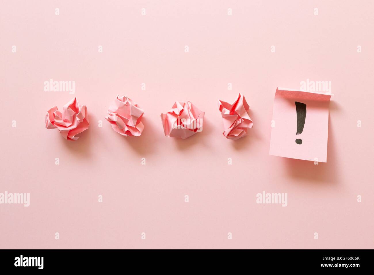 Exclamation mark and crumpled paper balls on pink background. Solution ...