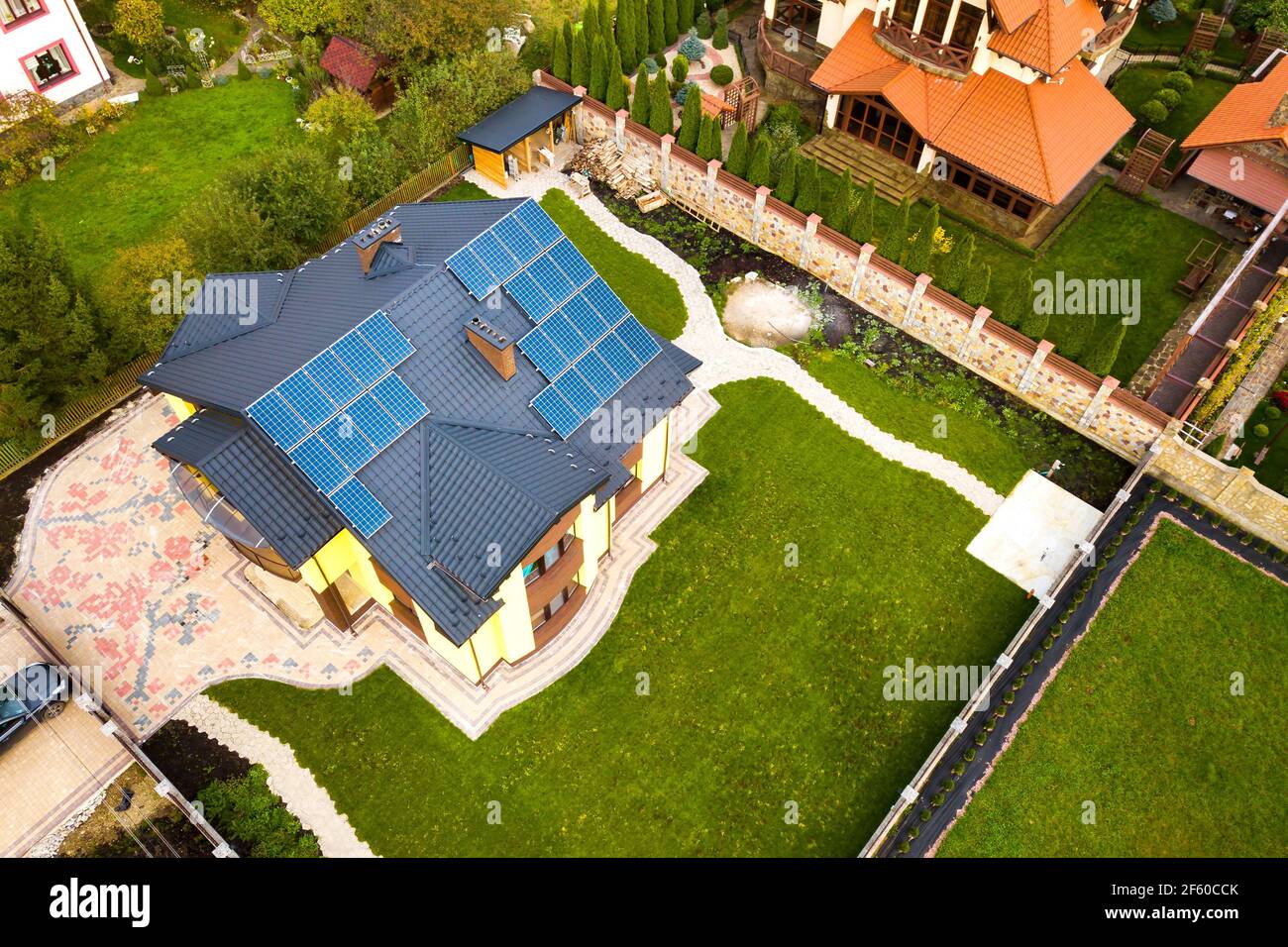 Aerial view of a private house with solar photovoltaic panels for ...