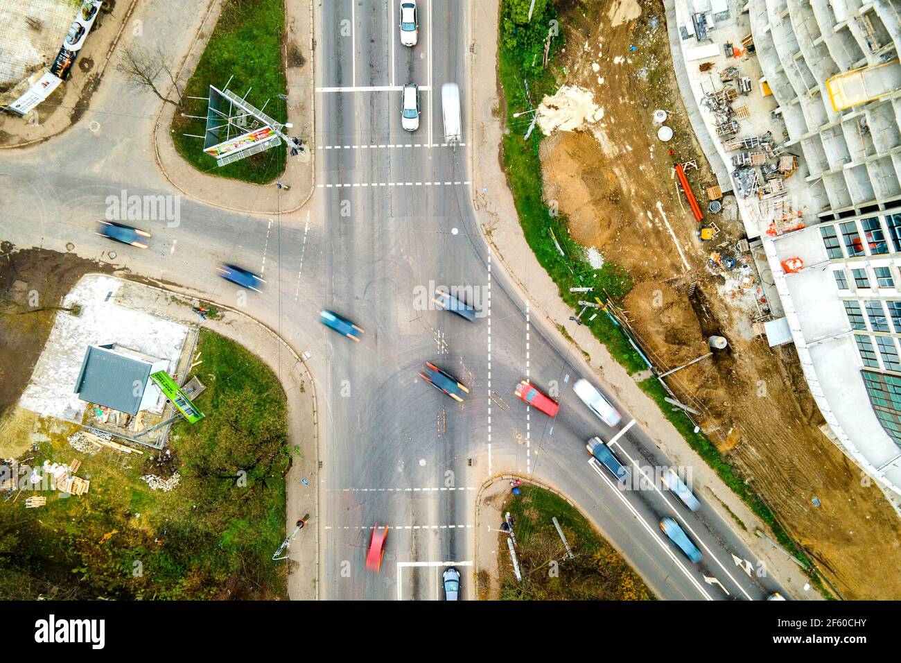 Top down aerial view of busy street intersection with moving cars ...