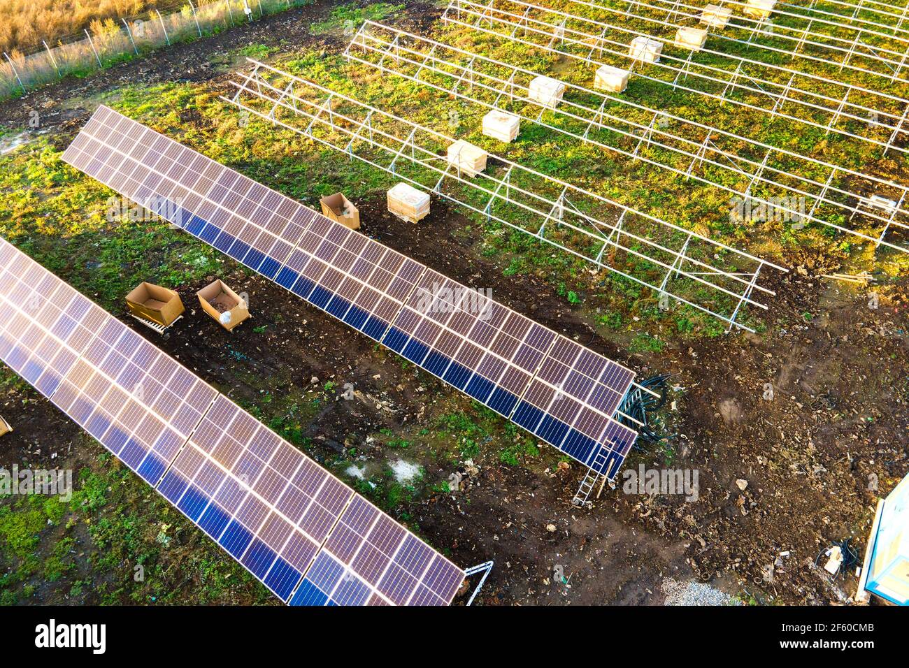 Aerial view of solar power plant under construction on green field ...