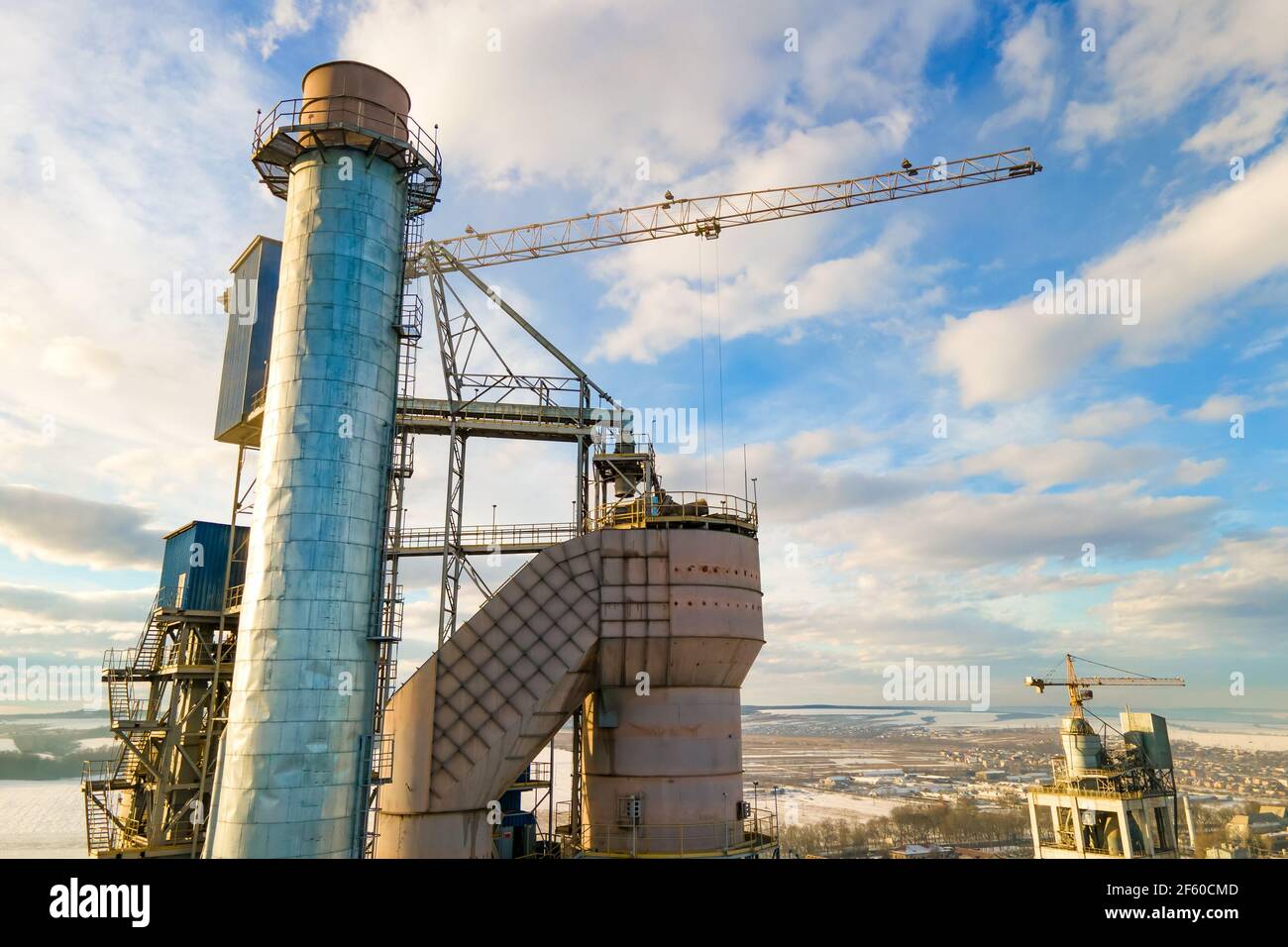 Aerial view of cement plant with high factory structure and tower crane ...