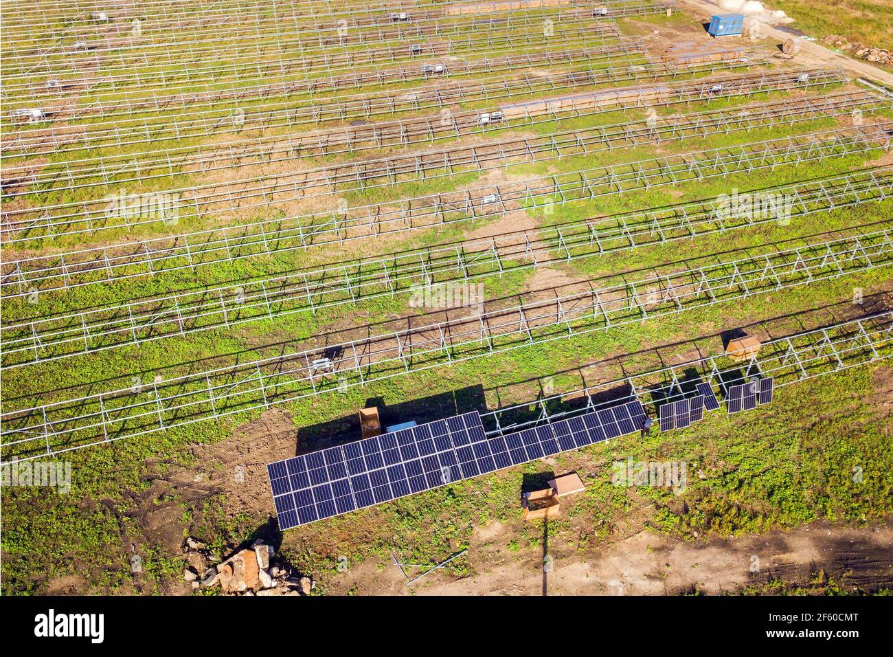 Aerial view of solar power plant under construction on green field ...