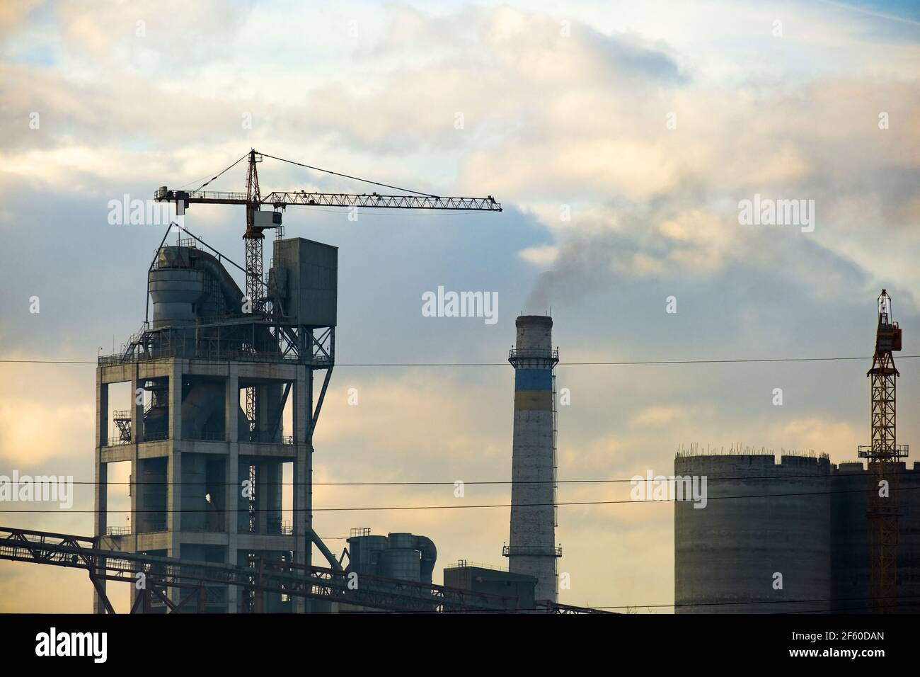 Cement plant with high factory structure and tower crane at industrial ...