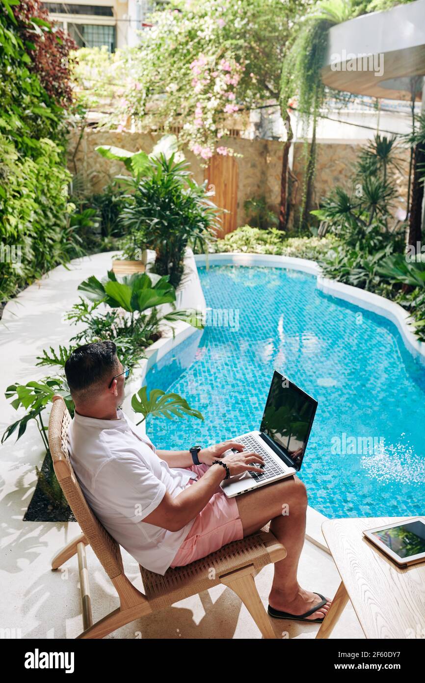 Using computer in swimming pool hi-res stock photography and images - Alamy