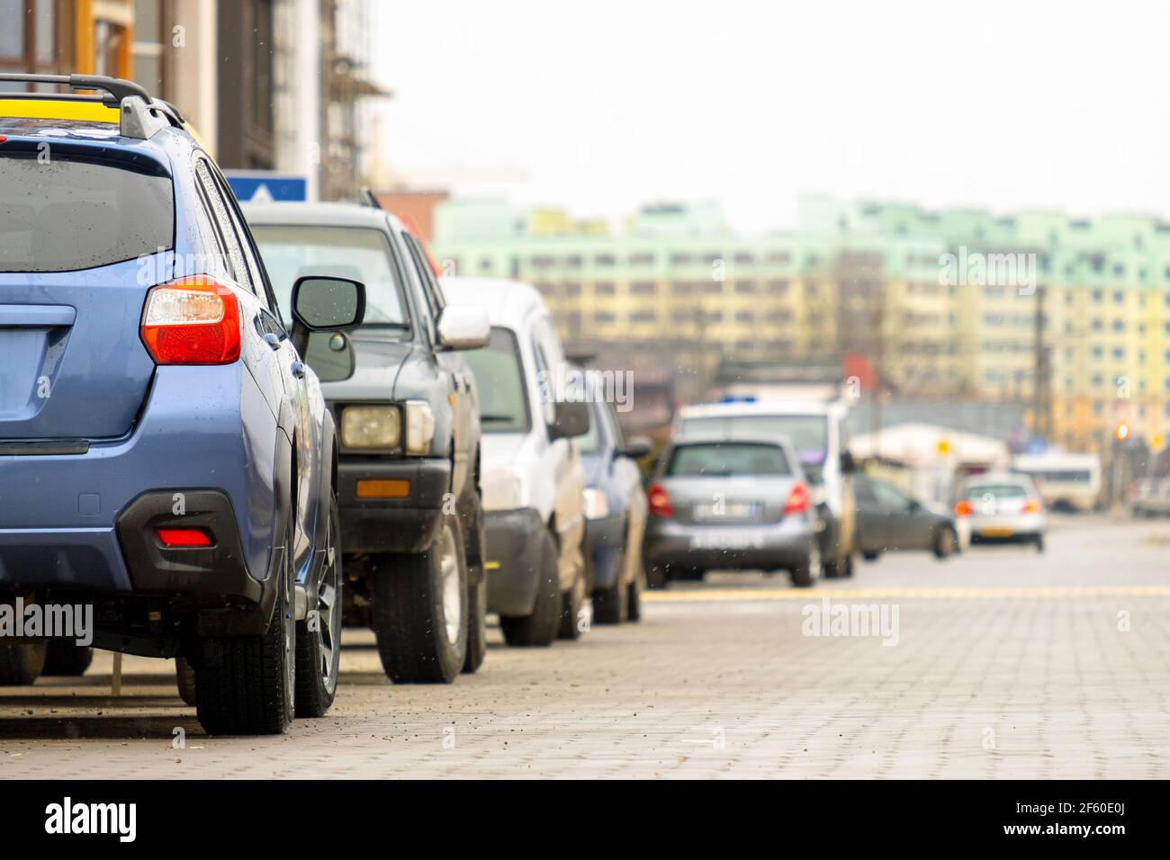 Cars parked in a row on a city street side Stock Photo - Alamy
