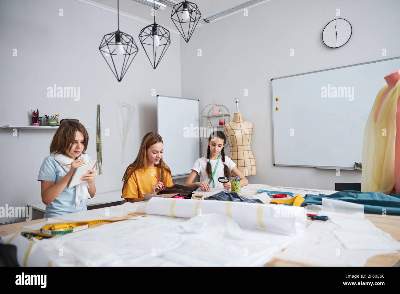 Girls together sewing hi-res stock photography and images - Alamy