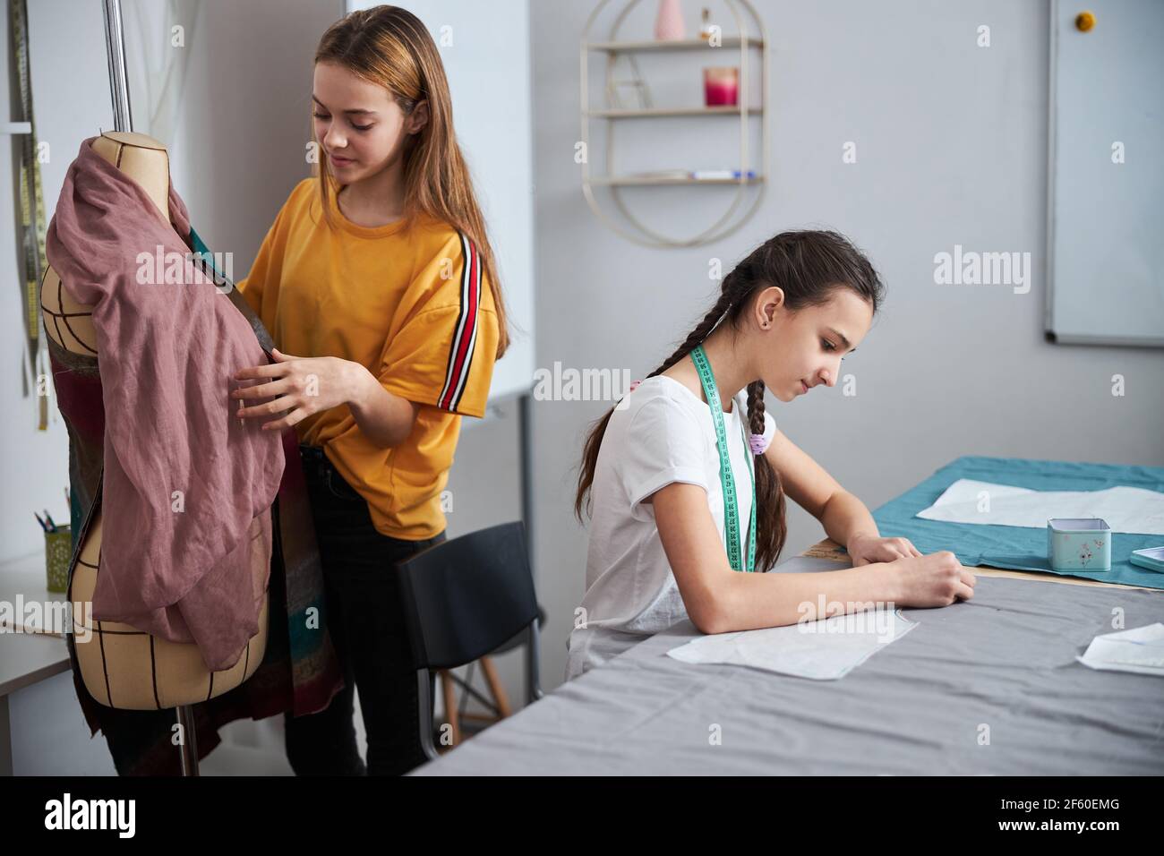 Two girls sewing hi-res stock photography and images - Alamy
