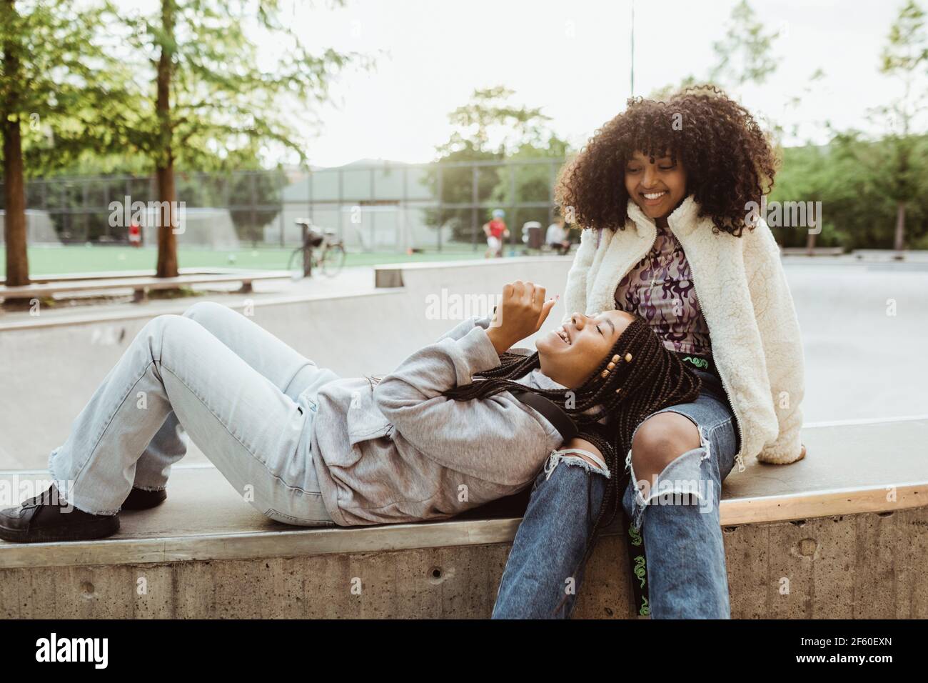 Friends Sitting On Lap