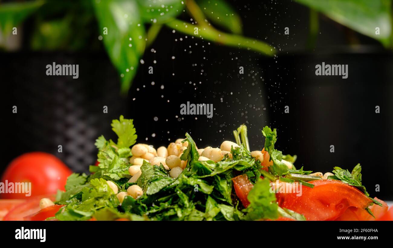 A plate of fresh vegetables and falling salt Stock Photo - Alamy