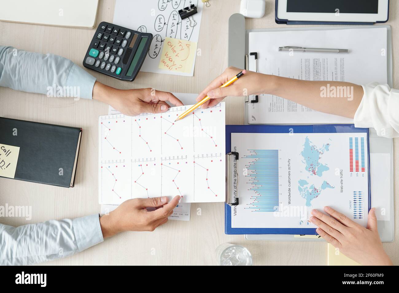 Hands of businesswoman giving report to colleague and explaining every ...