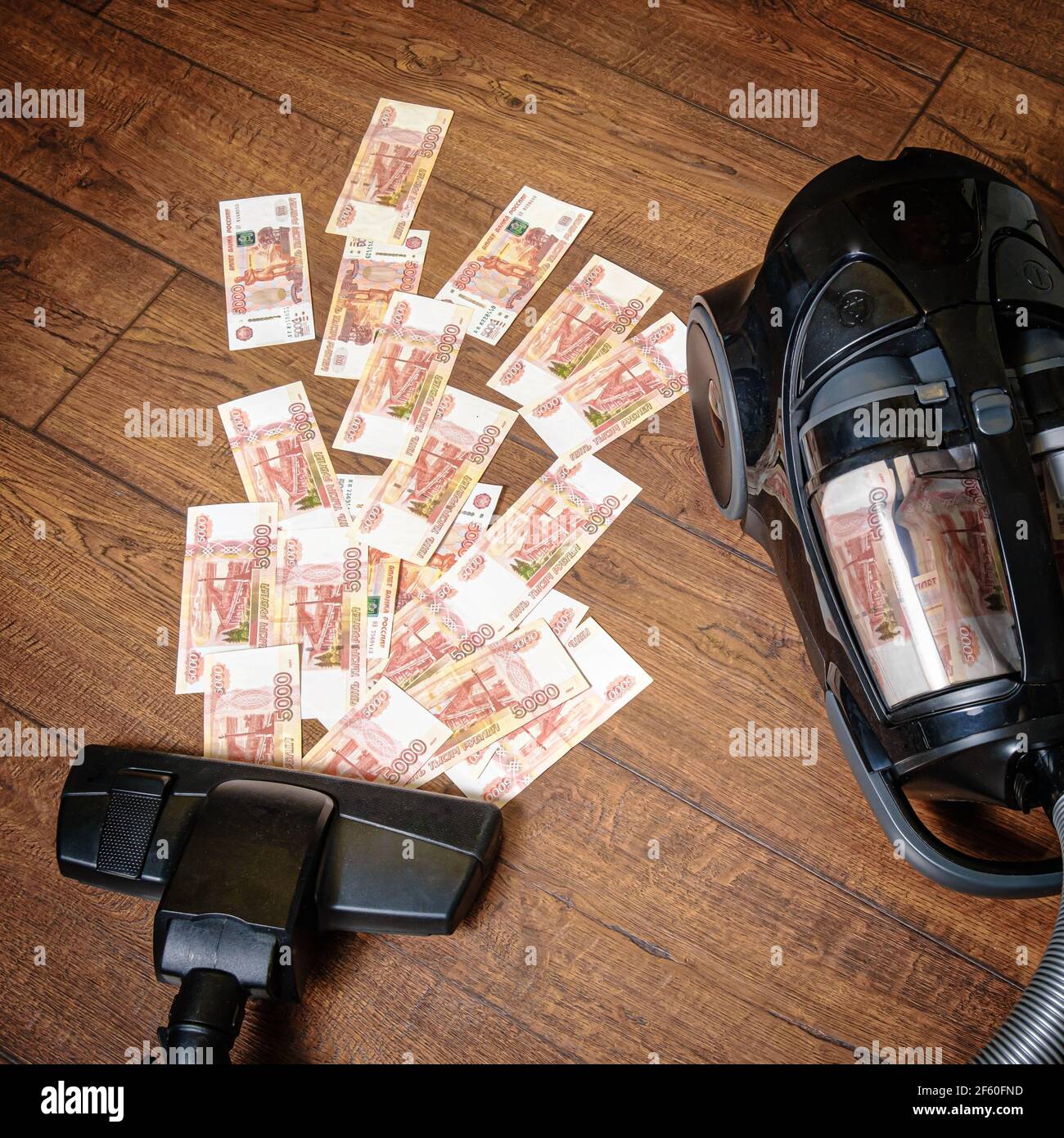 The cash vacuum cleaner picks up the money Stock Photo - Alamy