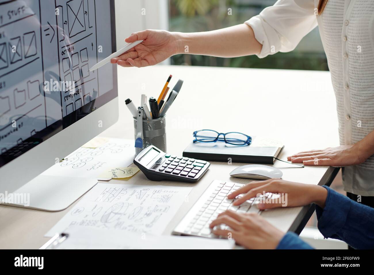 Project manager and ux designer discussing layout of new website page ...