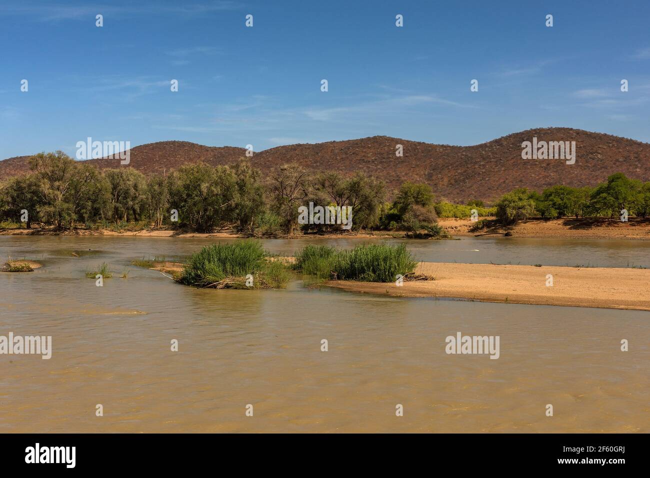Landscape view of the Kunene River, the border river between Namibia ...