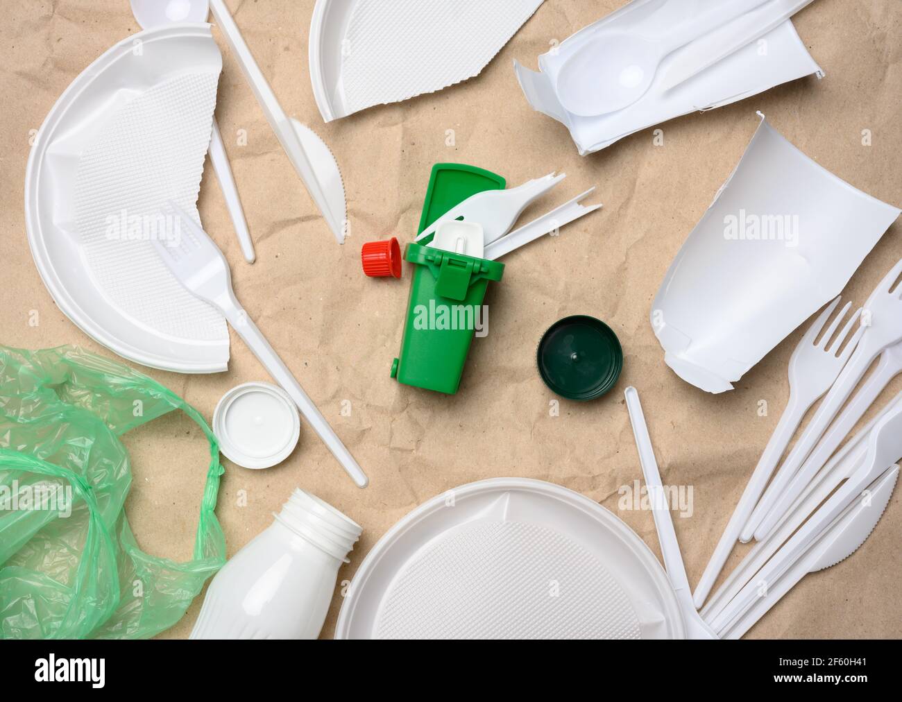 plastic waste from life on the background of brown kraft paper ...