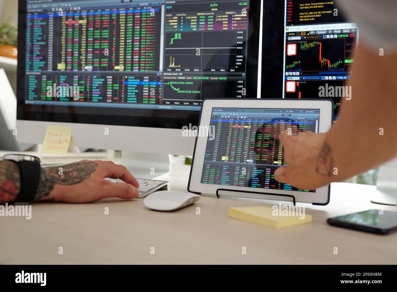 Close-up image of trader checking stock market data on screens of ...