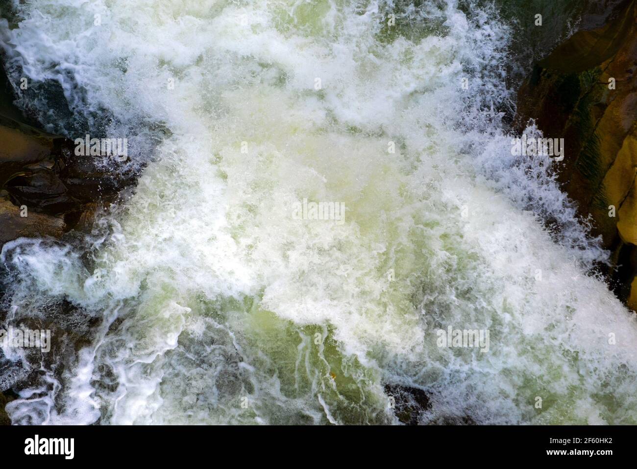 Aerial view of river waterfall with clear turquoise water falling down ...