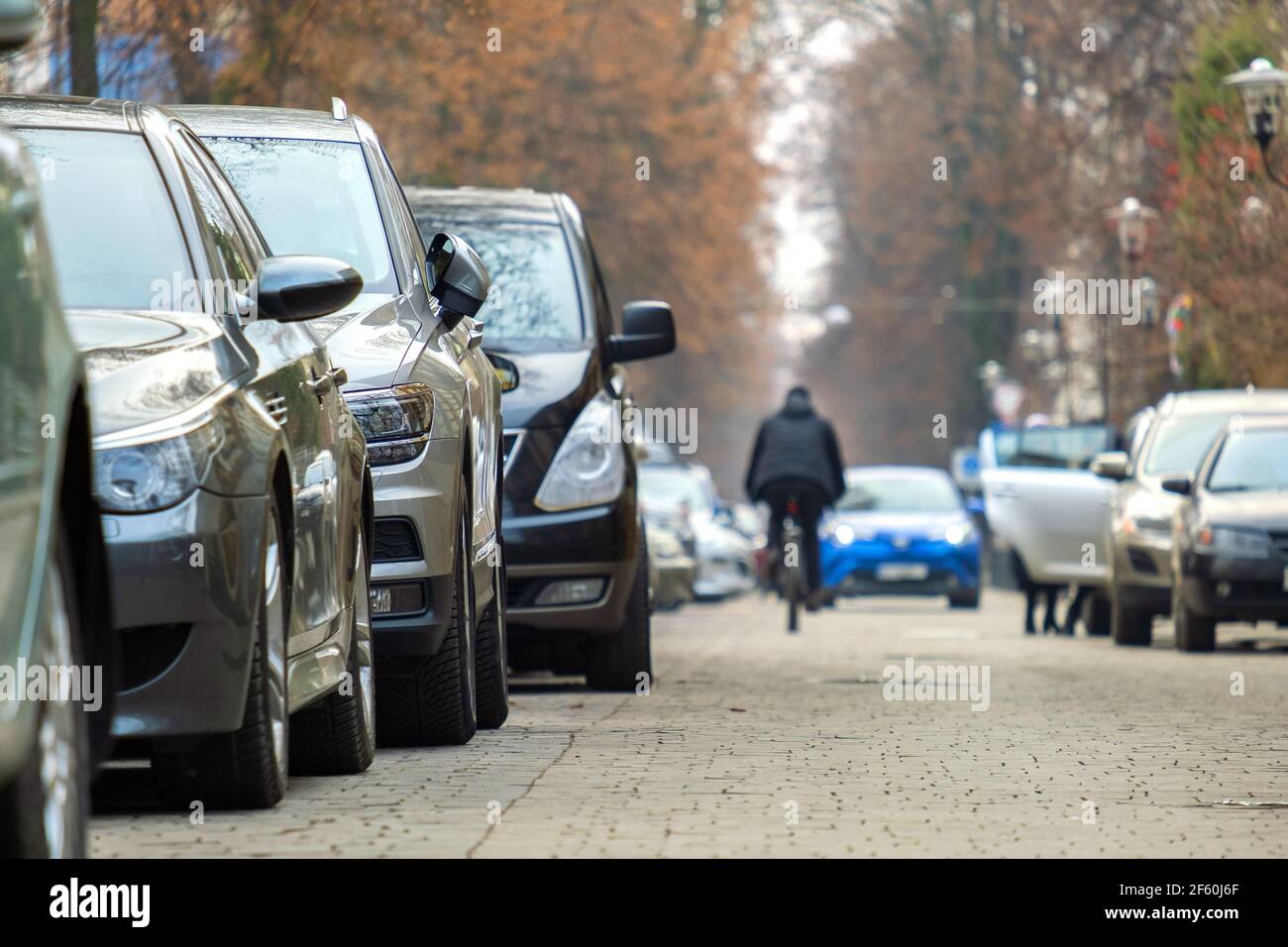 Cars parked in a row on a city street side Stock Photo - Alamy