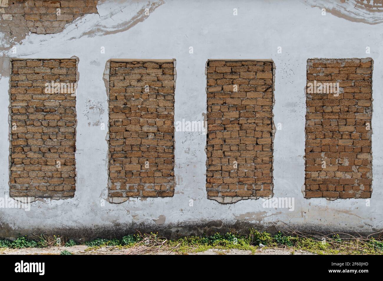 A wall with windows, which are covered with bricks, of a fermented ...