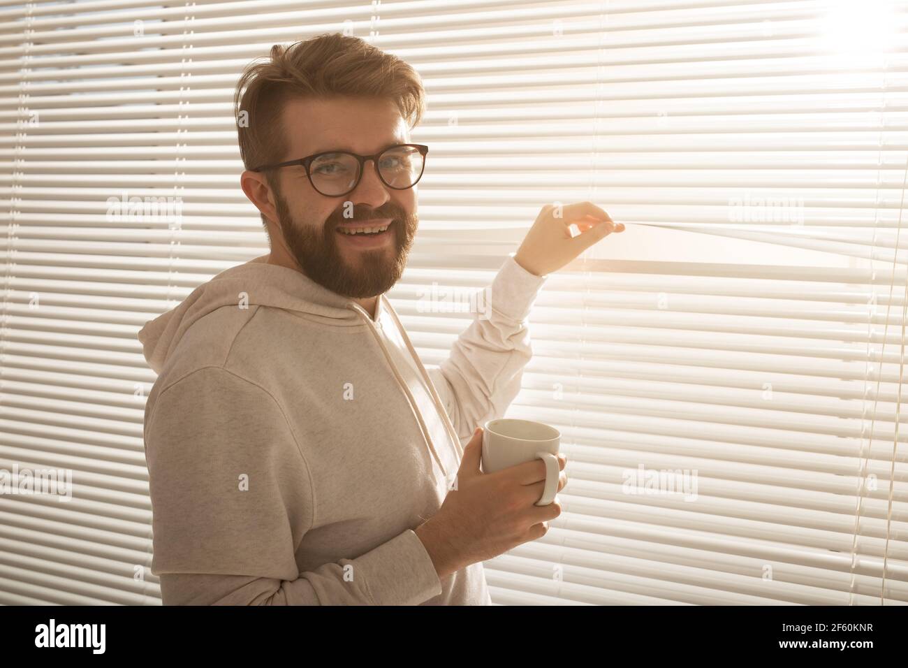 Man peeking out window hi-res stock photography and images - Alamy
