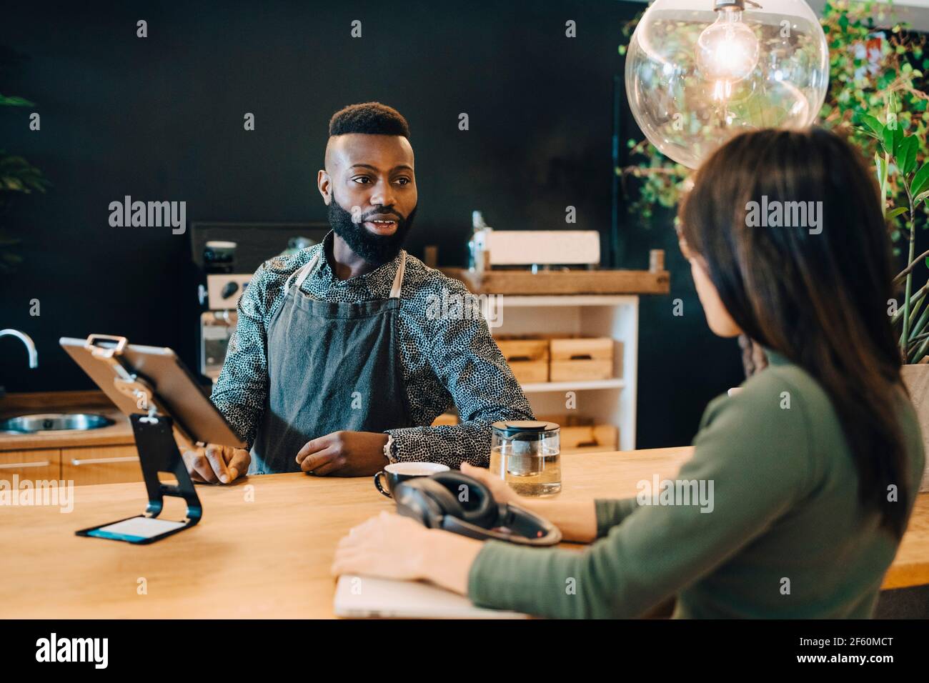 Cafe owner talking to customer hi-res stock photography and images - Alamy