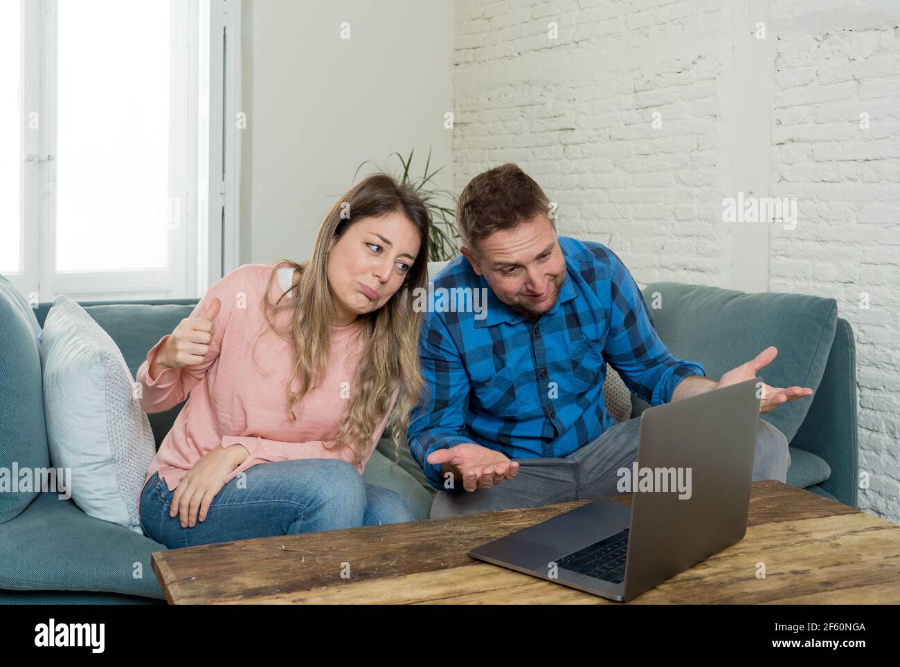 Life at home image of Sad couple video calling friends and family using ...