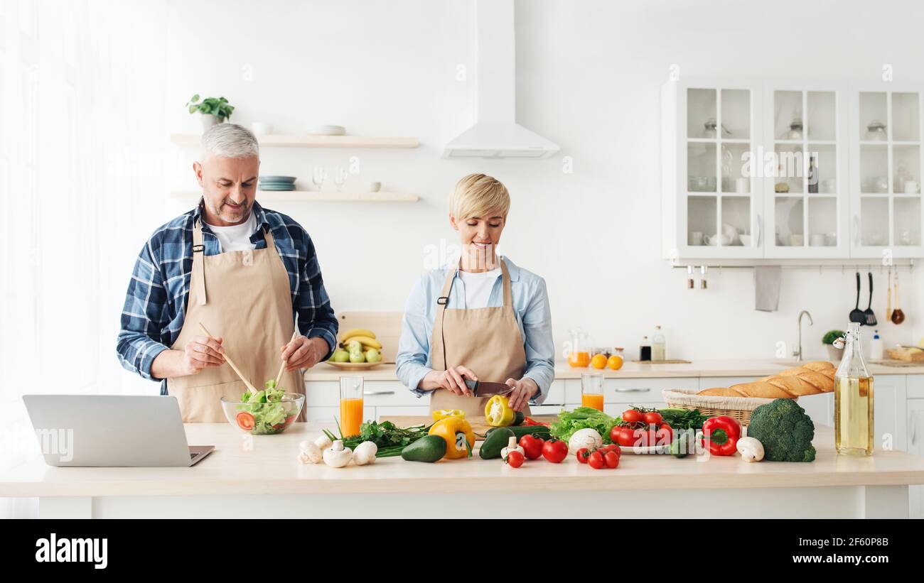 Adult couple prepare food together for family dinner Stock Photo - Alamy
