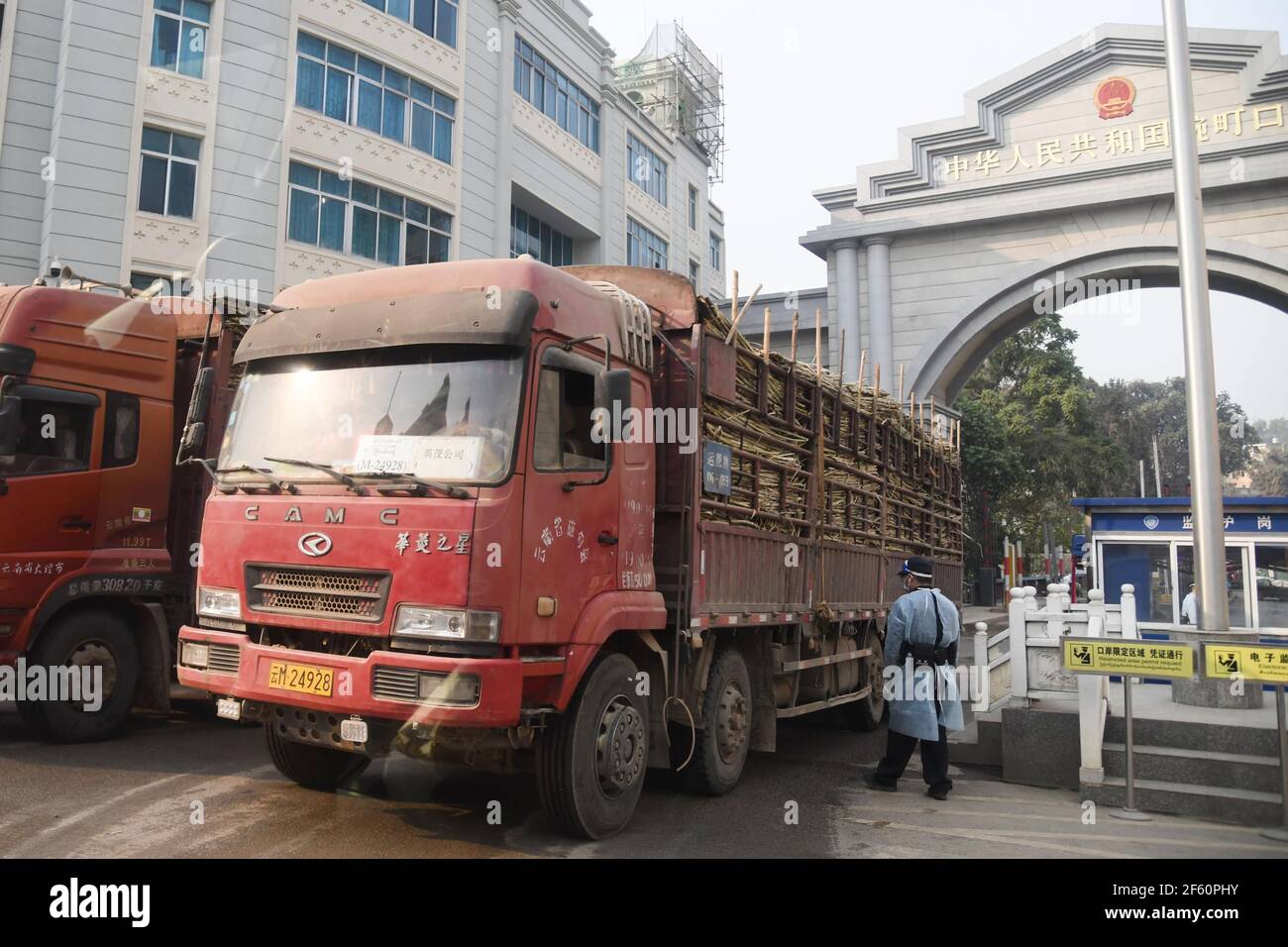 A truck carrying sugar cane goes through a border post in Ruili, a ...