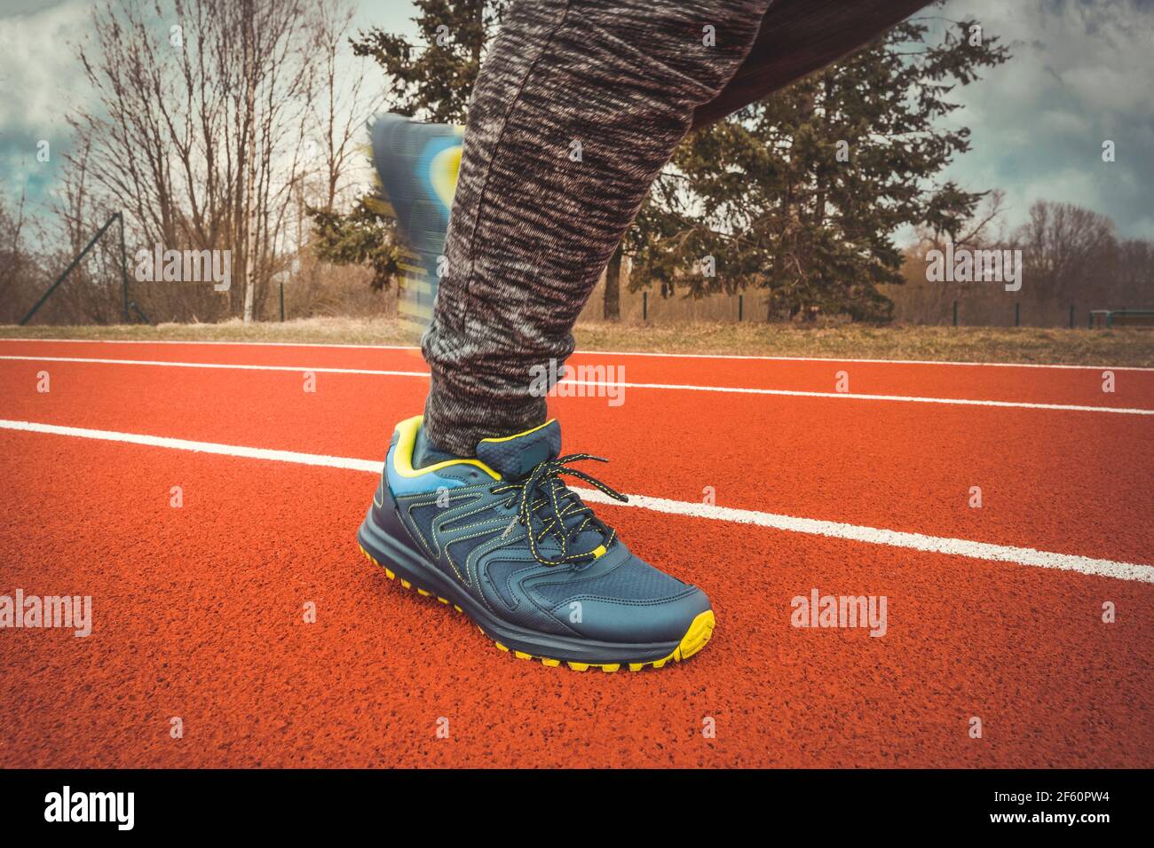 Runner Feet Running on Stadium Close Up. Legs of a runner Running along ...